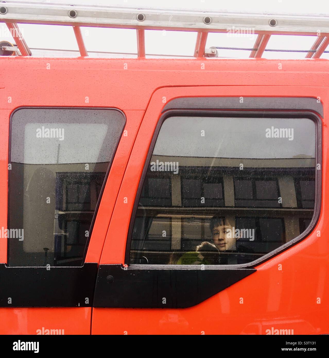Boy child looking out of a fire engine window at Childrens Day Stock ...