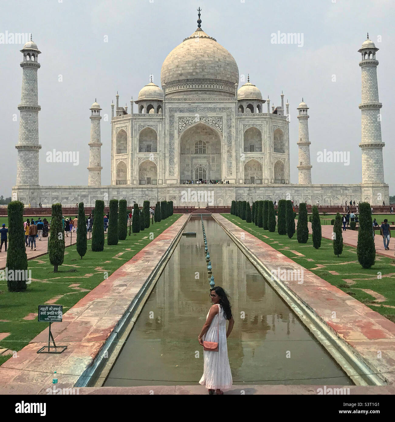 a girl taking photo in front of taj mahal’s magnificent view Stock ...