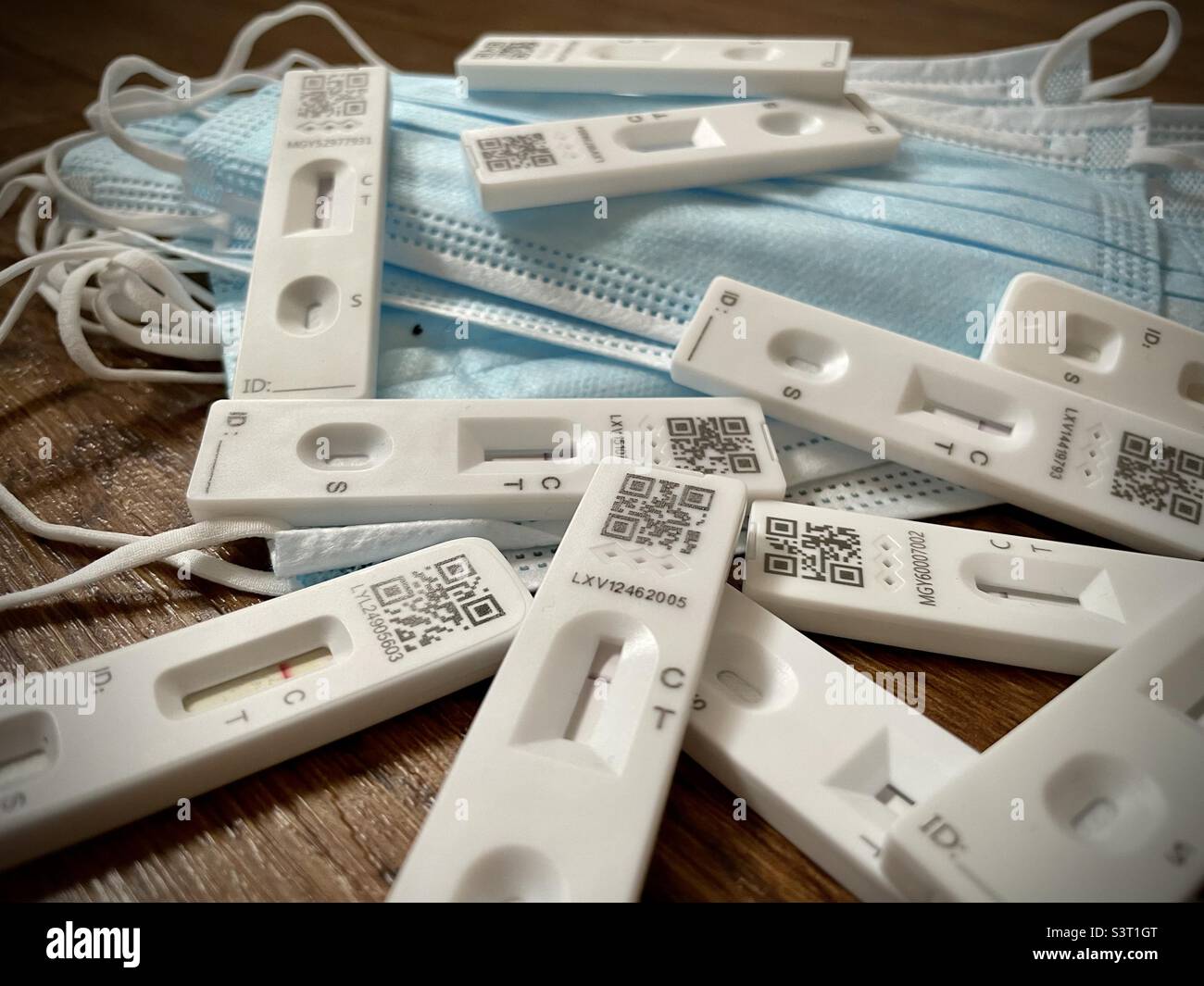 Pile of lateral flow tests and COVID face masks Stock Photo - Alamy
