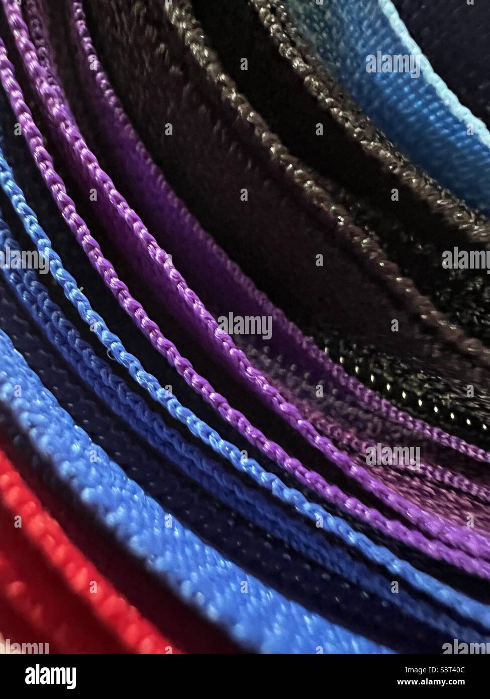 Colorful zipper assortment of textiles curves Stock Photo - Alamy
