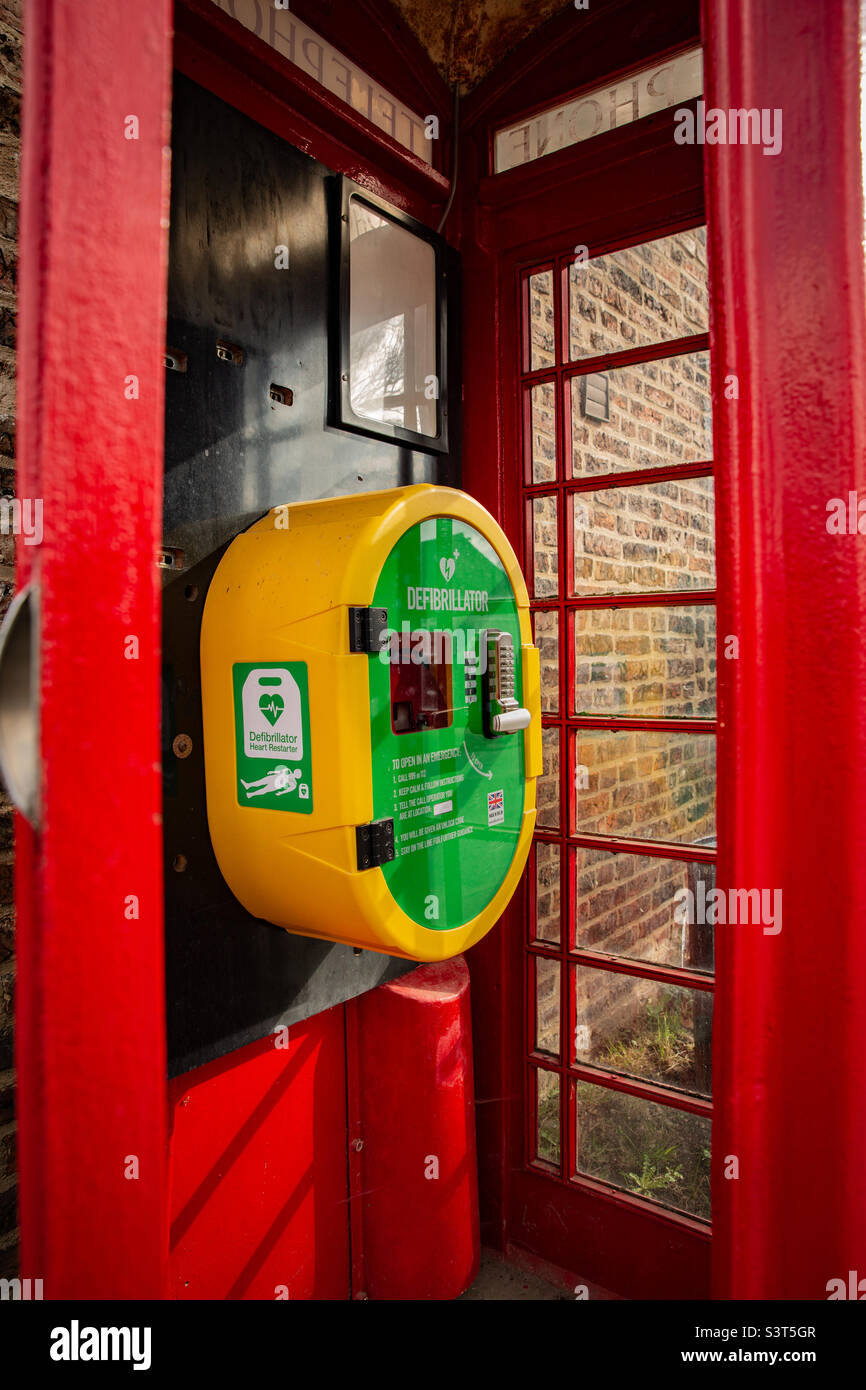 An emergency heart defibrillator and monitor in a British red public ...