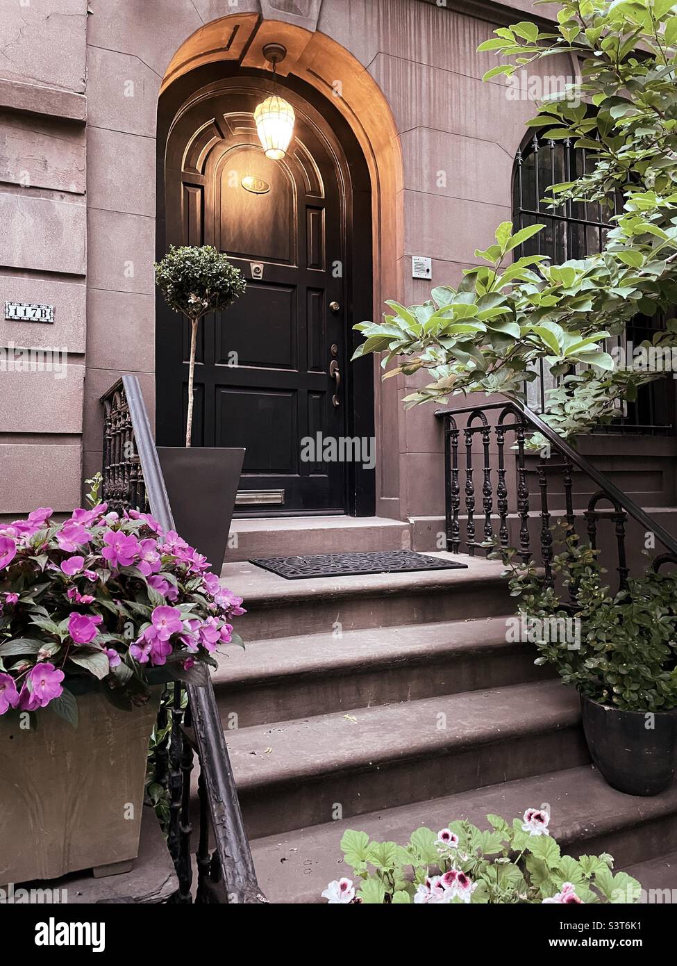 Beautifully landscaped front door and porch of a brownstone in the ...