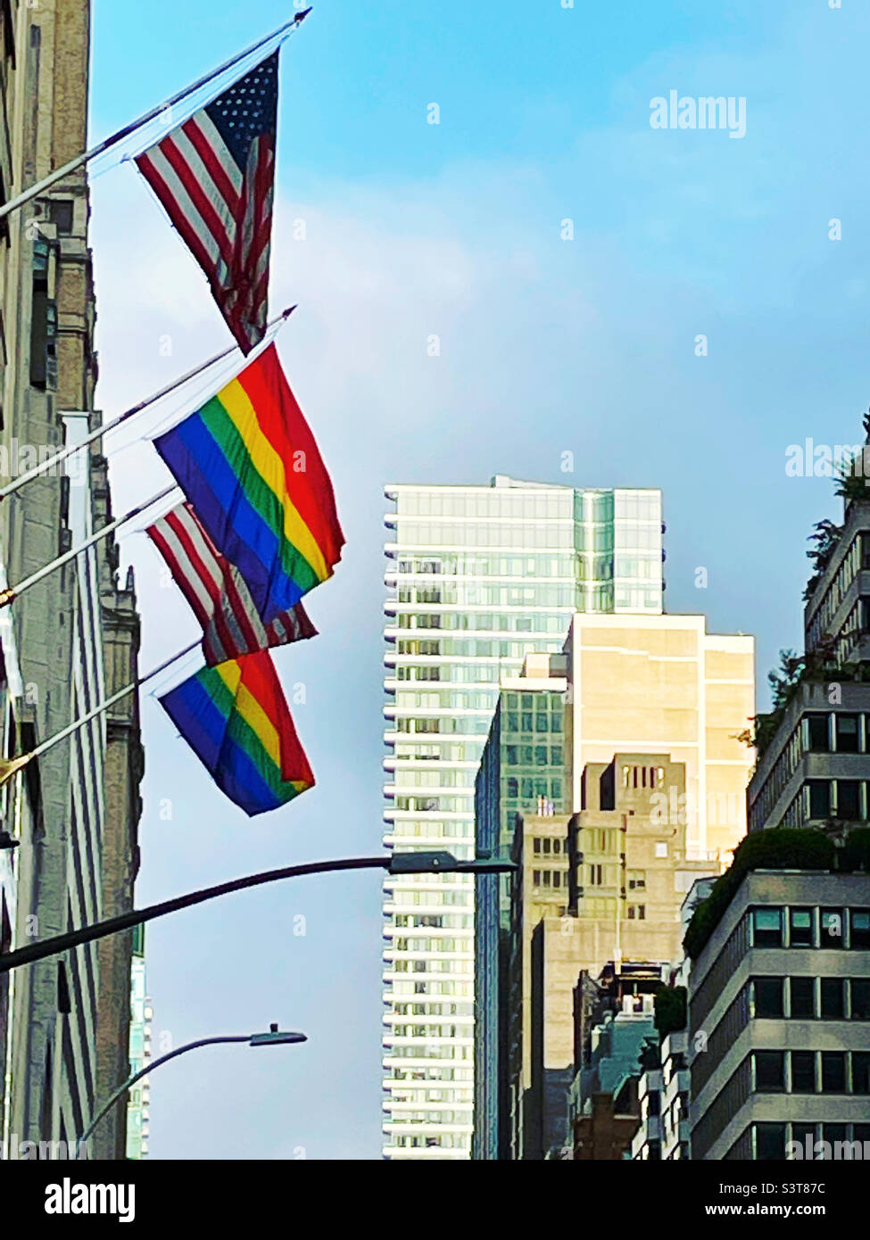 Gay pride rainbow flags and American flags hanging from a New York City ...