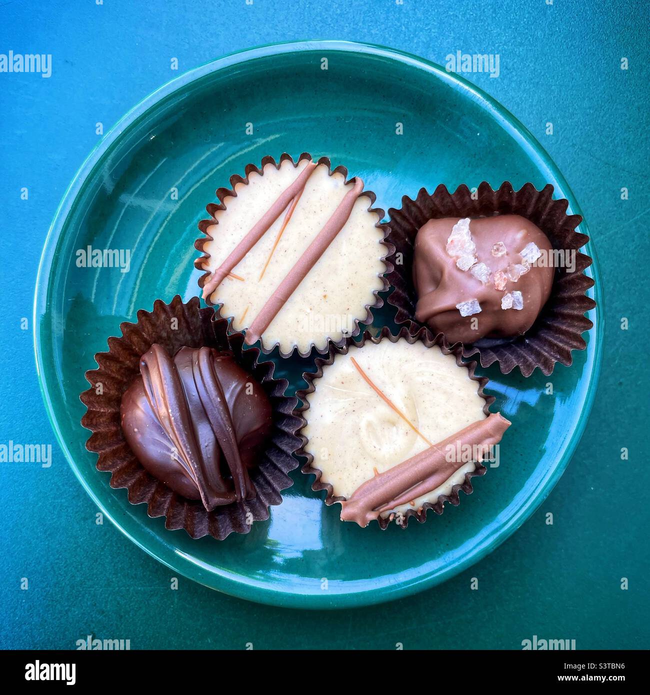 Specially chocolate treats on a teal coloured pottery plate Stock Photo ...