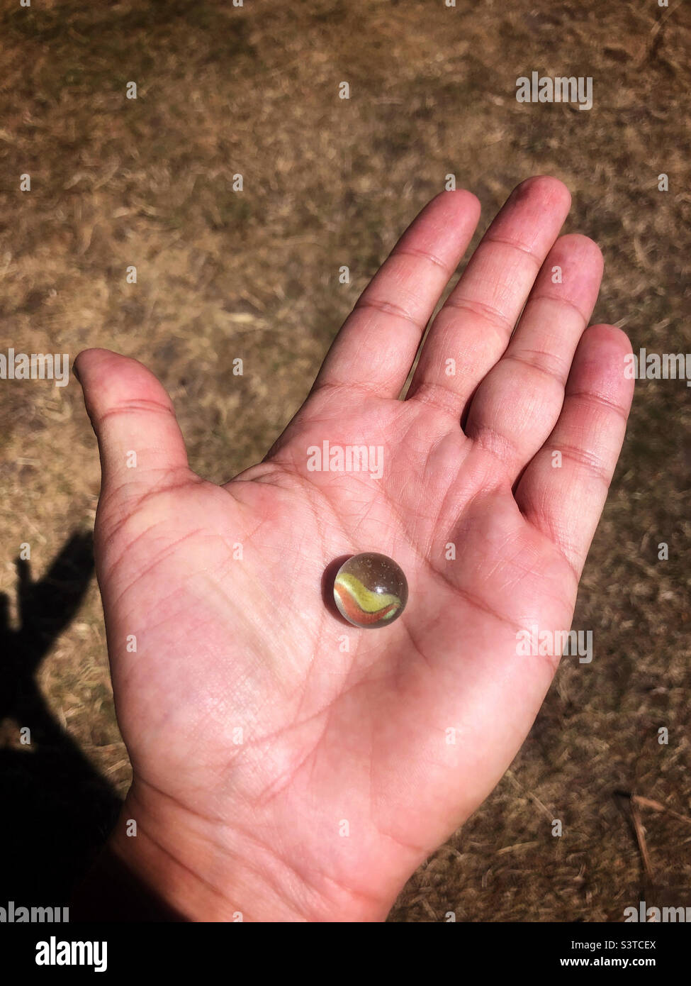 Marble in hand Stock Photo - Alamy