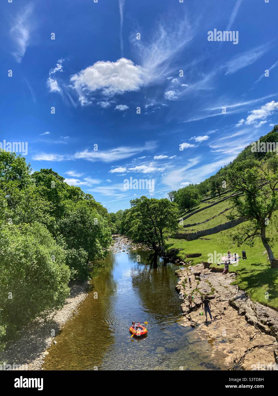 Children playing in a dingy in the River Wharfe Kettlewell Yorkshire ...