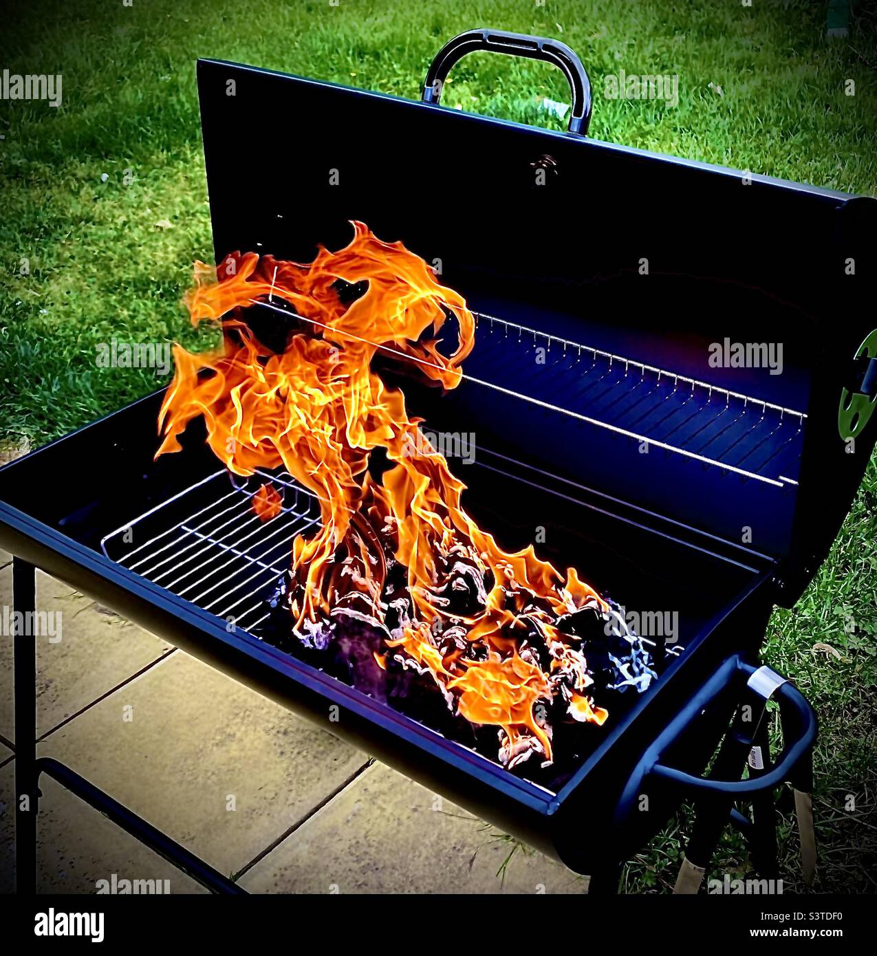 Freshly light BBQ with beautiful flames licking the air Stock Photo - Alamy