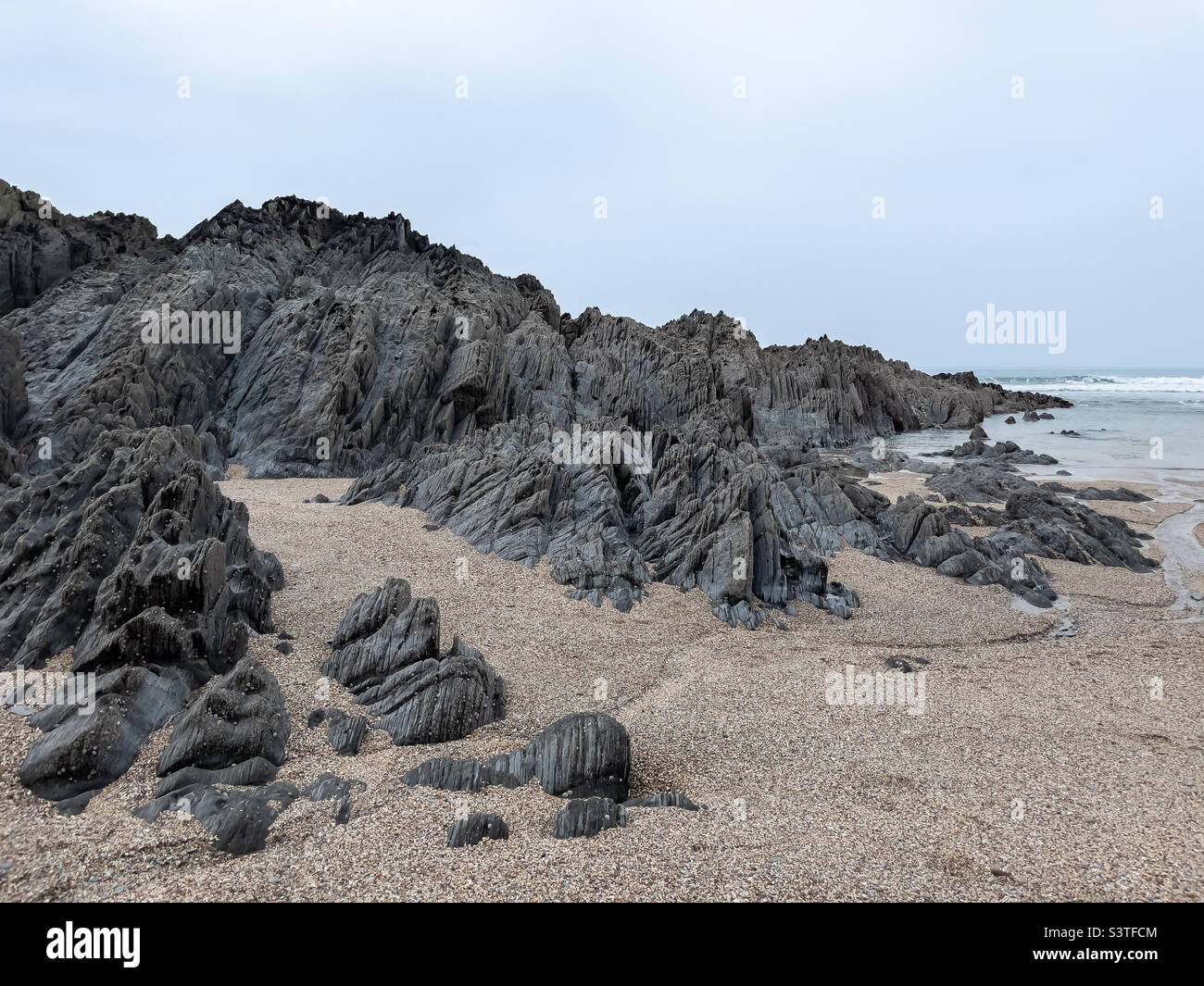 Slate, quartz and sandstone rock formations at Barricane Beach ...