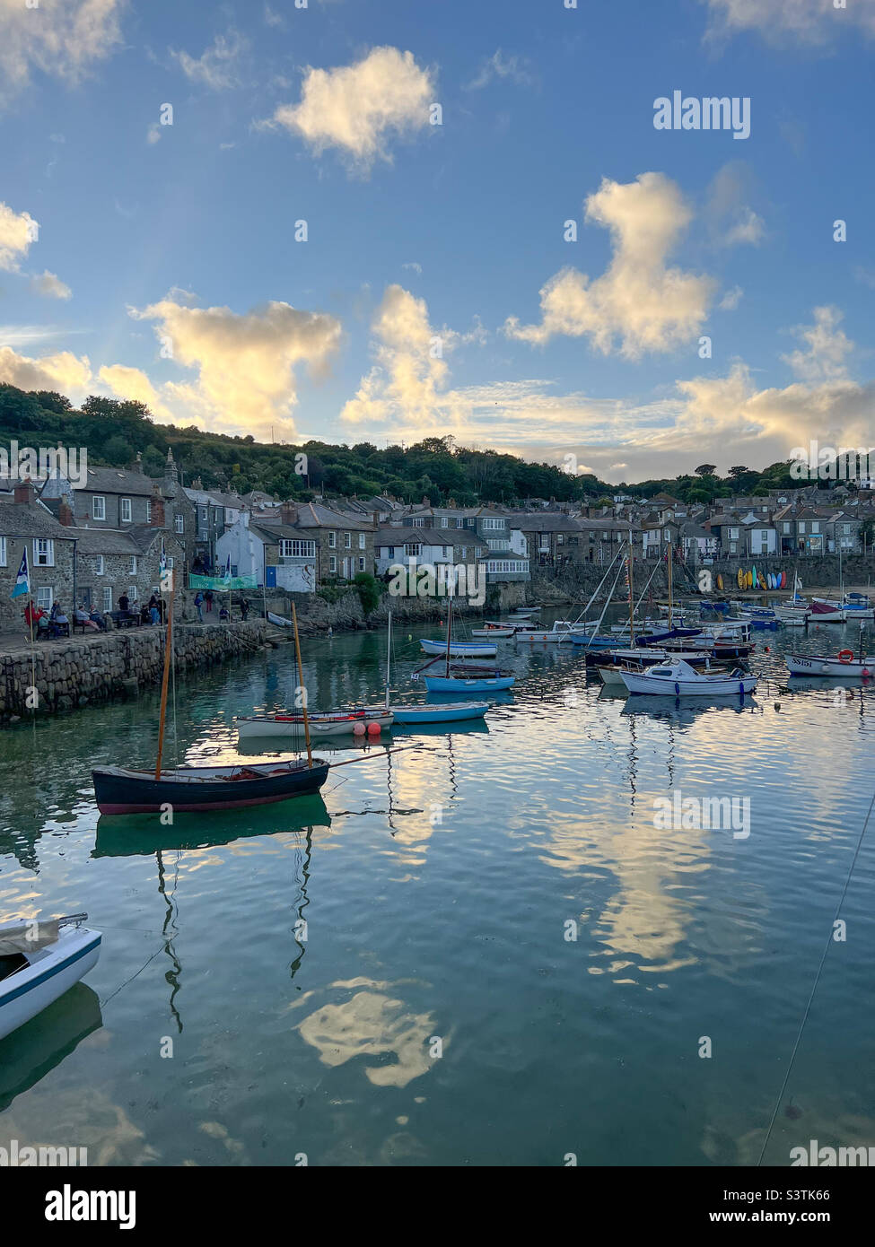 Boats anchored in Mousehole harbour at sunset Stock Photo - Alamy