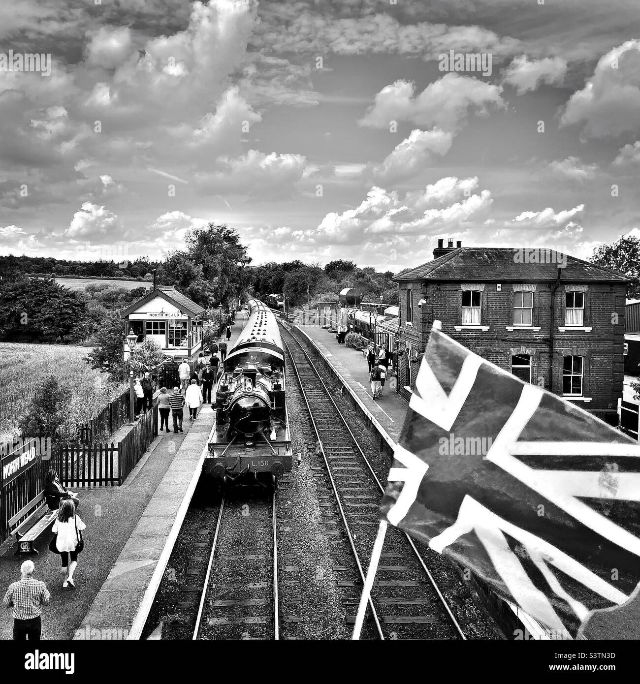 Steam train and flag Stock Photo - Alamy