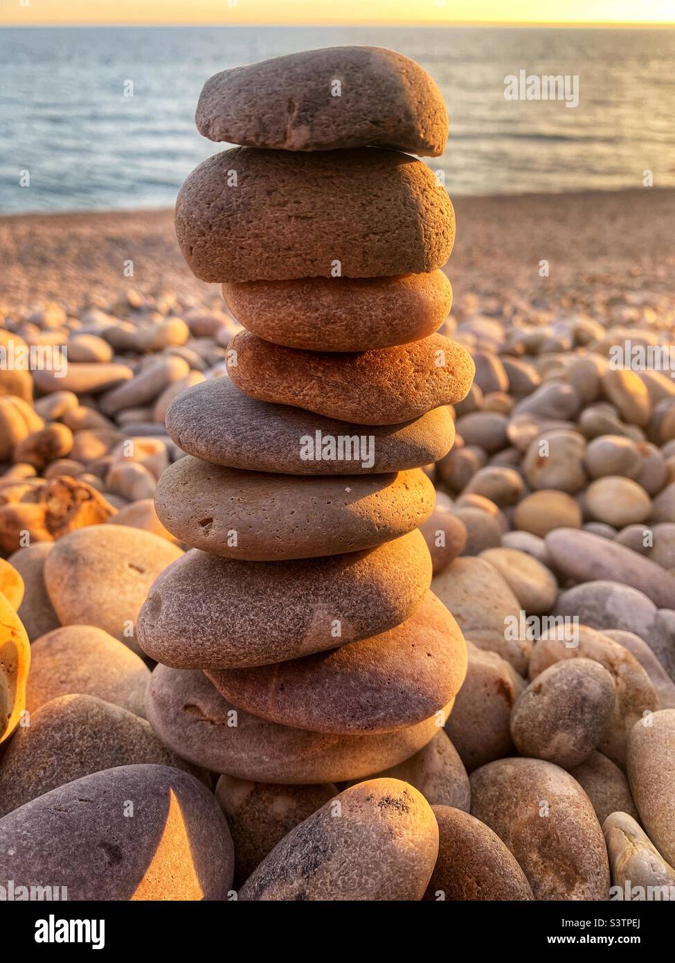 Stack of pebbles on a pebble beach Stock Photo - Alamy