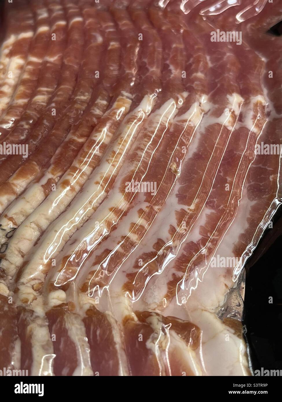 Bacon in plastic packaging Stock Photo - Alamy