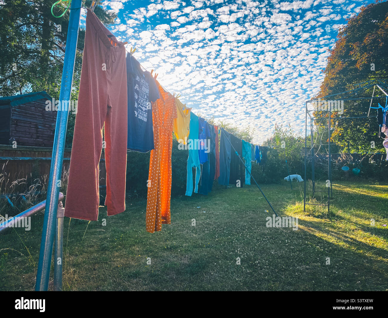 Washing hanging on a washing line with a blue sky with lots of small ...