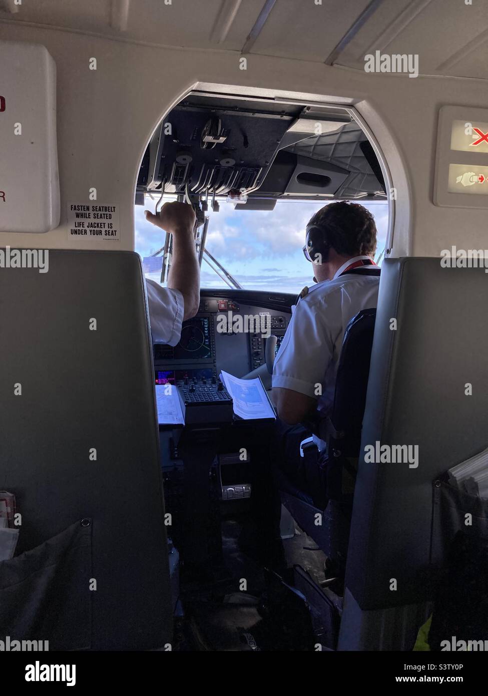 Airplane crew in the cockpit preparing to land a light aircraft Stock ...