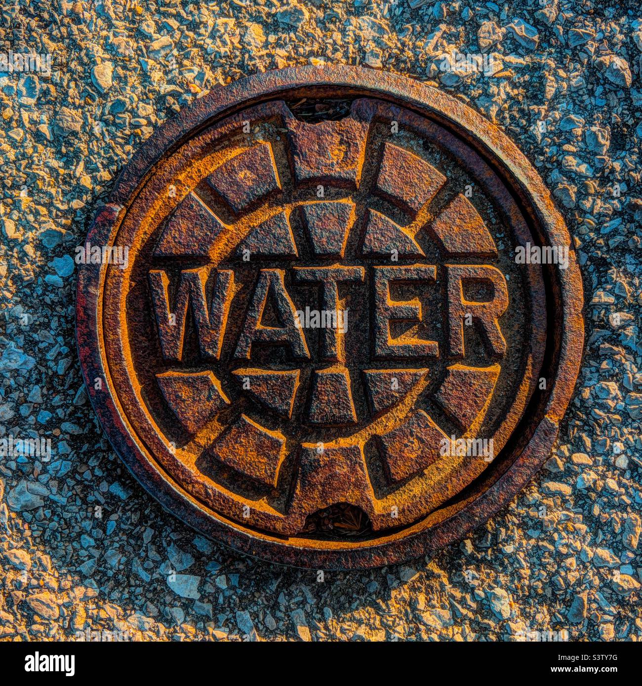 Water valve lid on asphalt at sunset. iPhone Stock Photo - Alamy