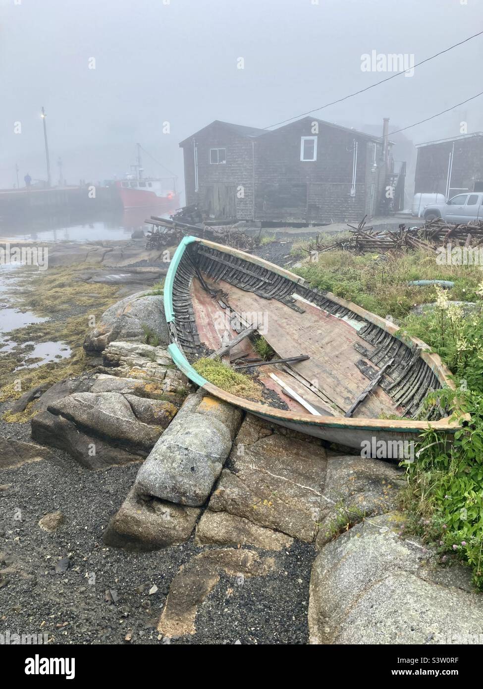 A old weathered dory in the fog of Peggys Cove Stock Photo - Alamy