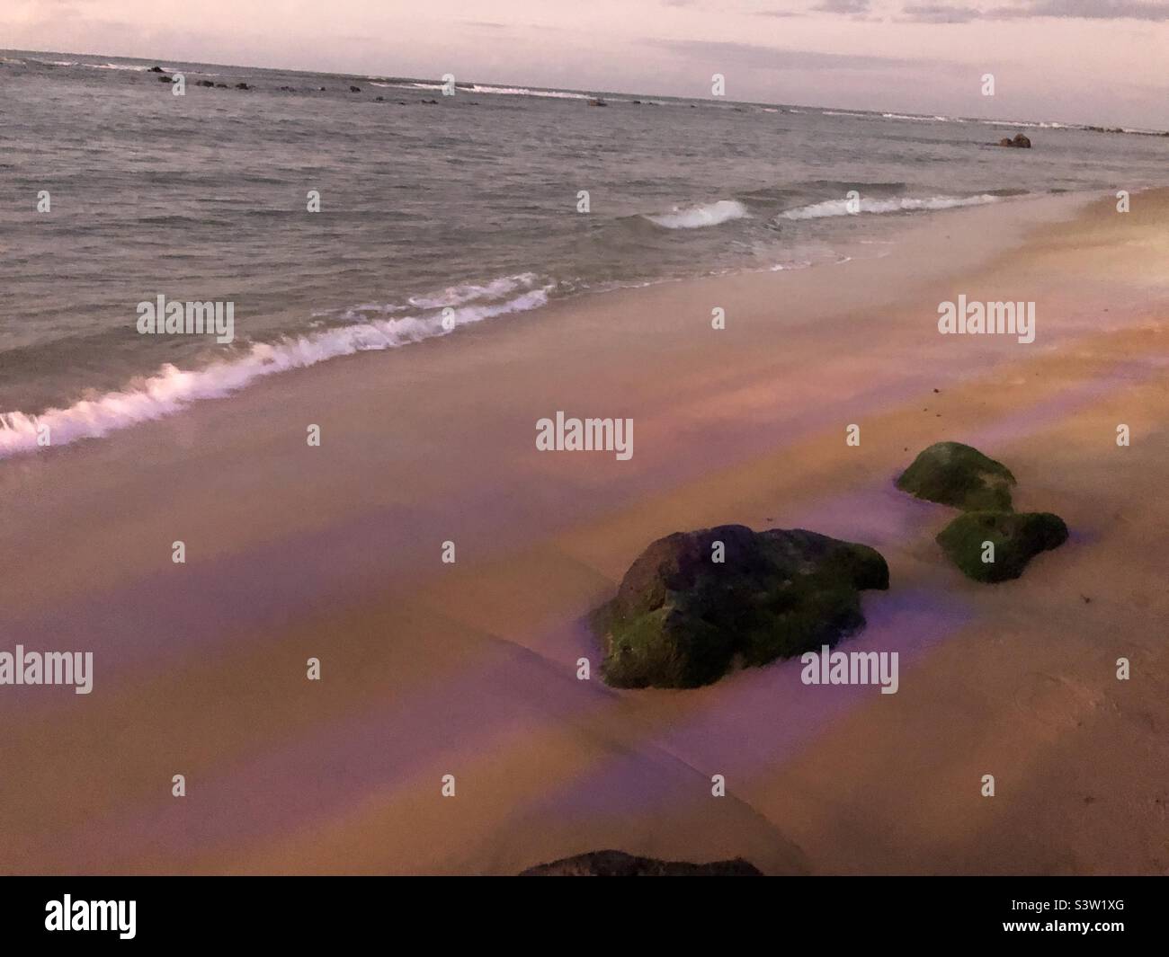 Light reflections on the beach at sunset Stock Photo - Alamy