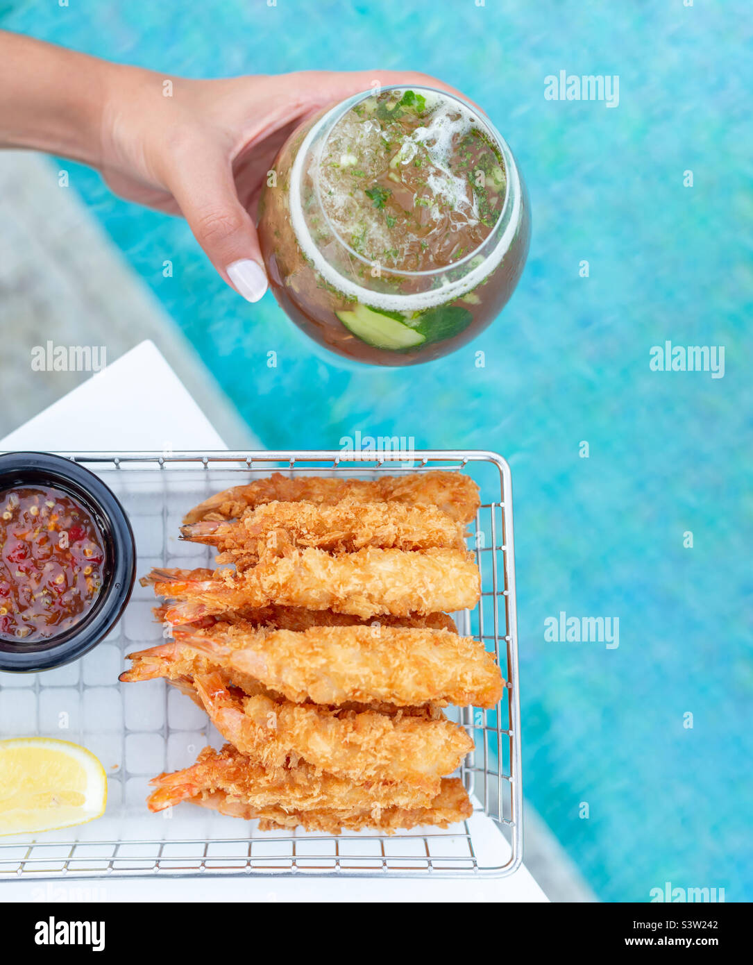 Snacking by the pool in summer Stock Photo - Alamy