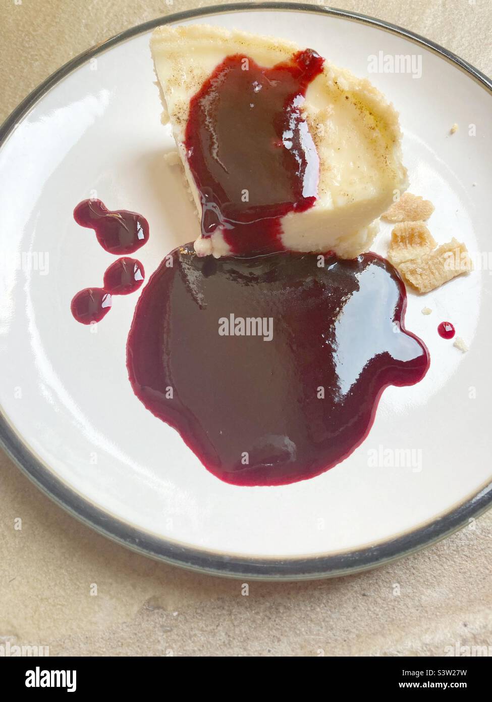 Blackcurrant sauce poured over a slice of egg custard pie Stock Photo ...