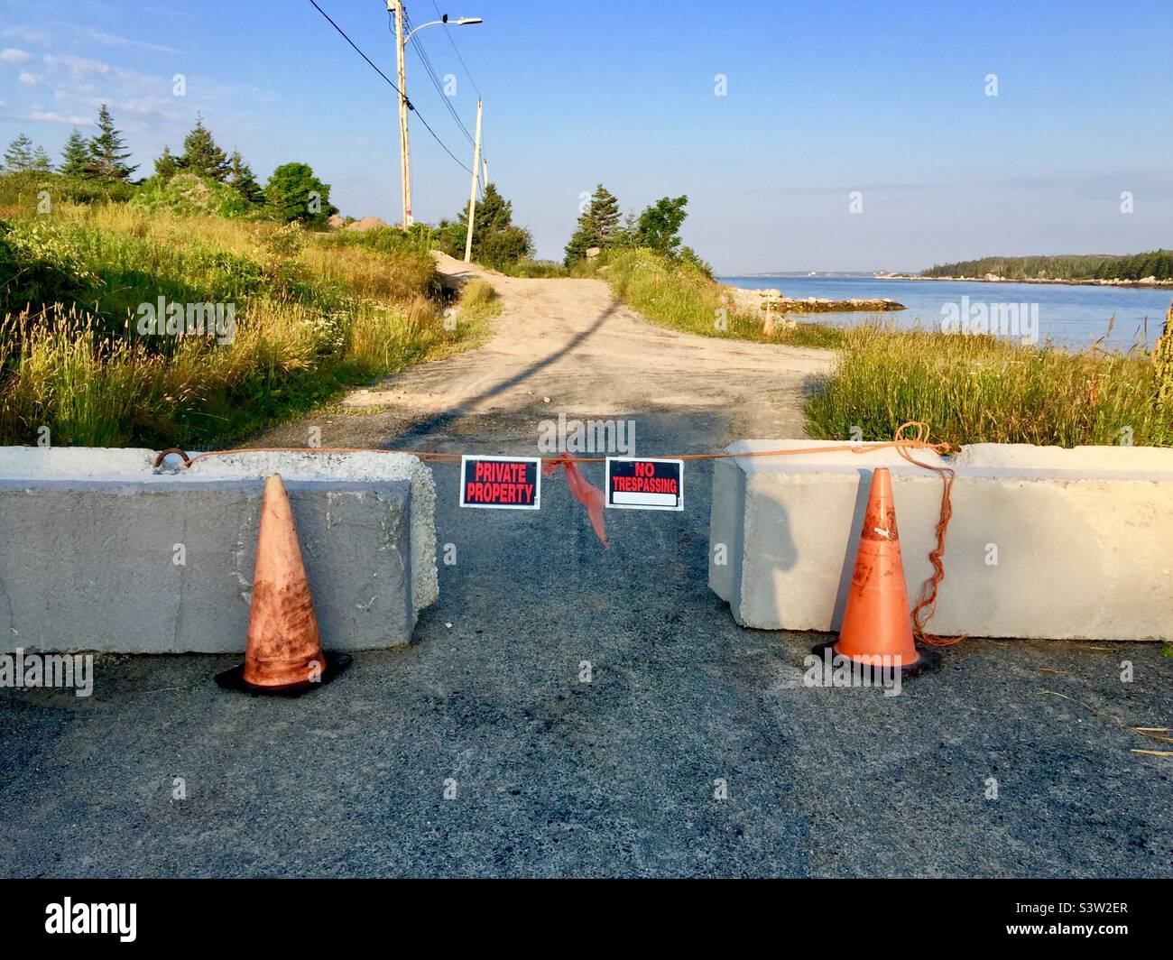 Scenic area with ocean and evergreen trees blocked. Private property ...