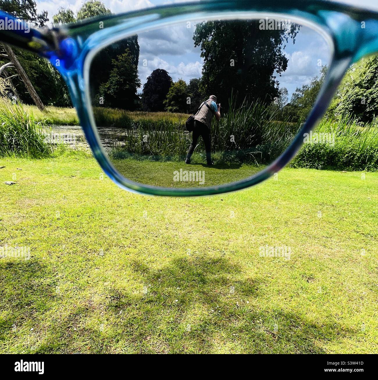 Photographer viewed through a lens Stock Photo - Alamy