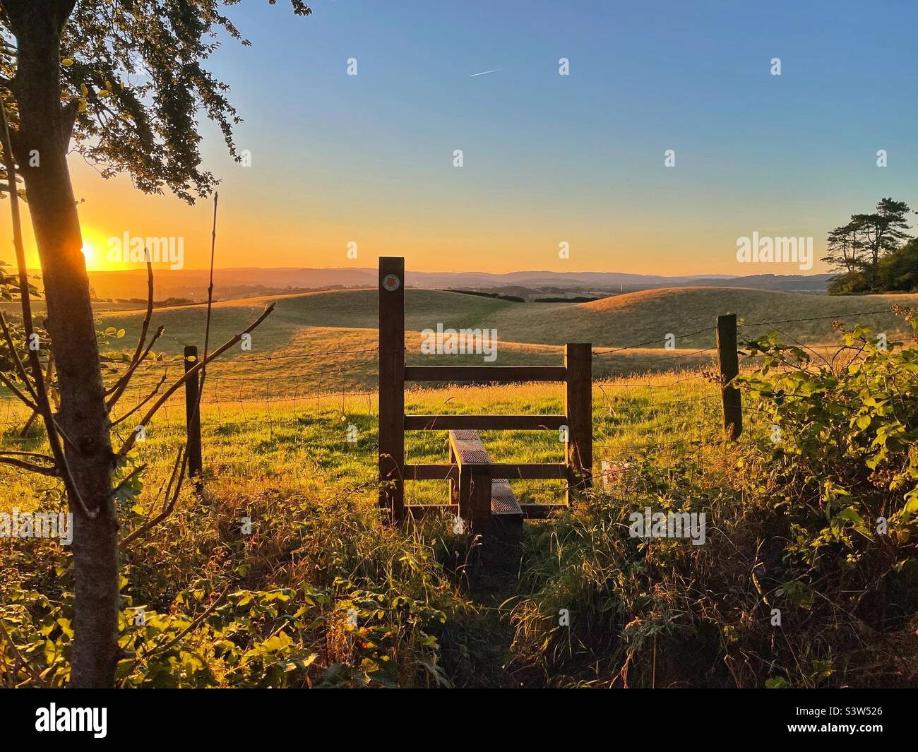 Country stile leading to rolling hills at sunset, Vale of Glamorgan ...