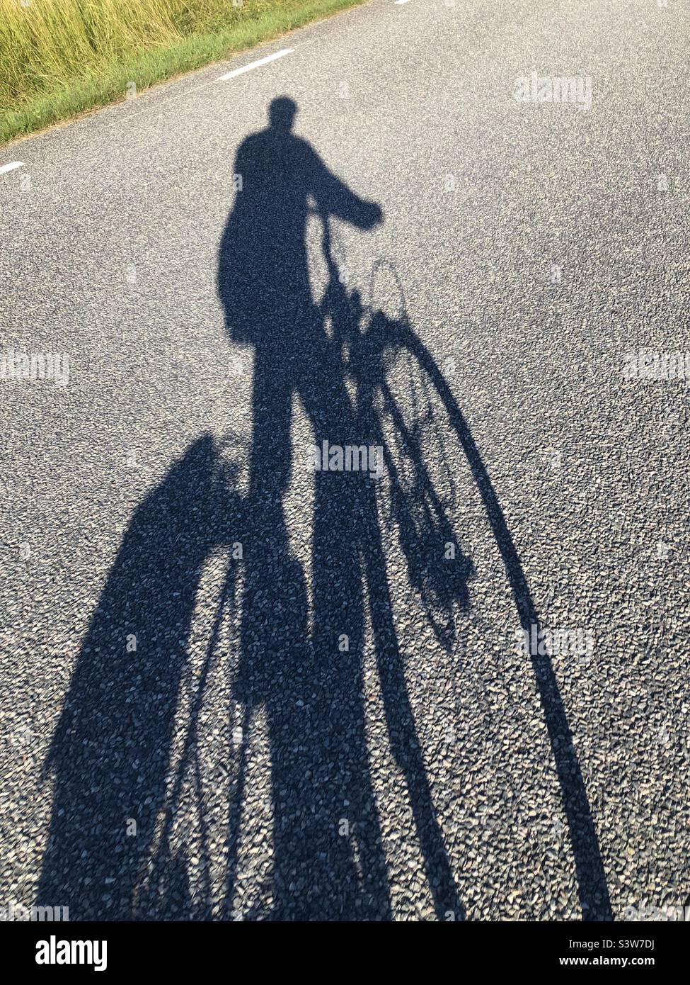 Shadow of a man riding a bike Stock Photo - Alamy