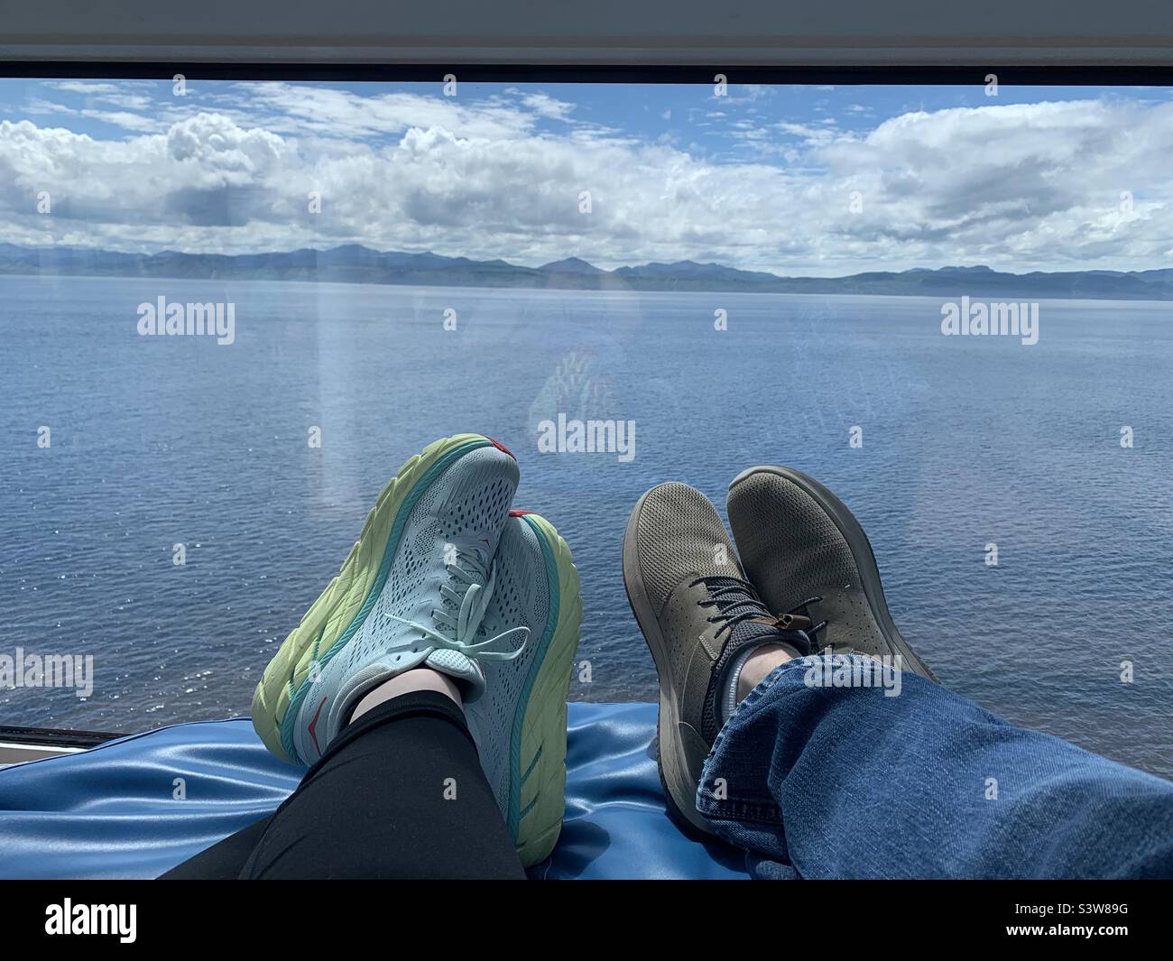 Relaxing feet while watching Alaska pass by Stock Photo - Alamy