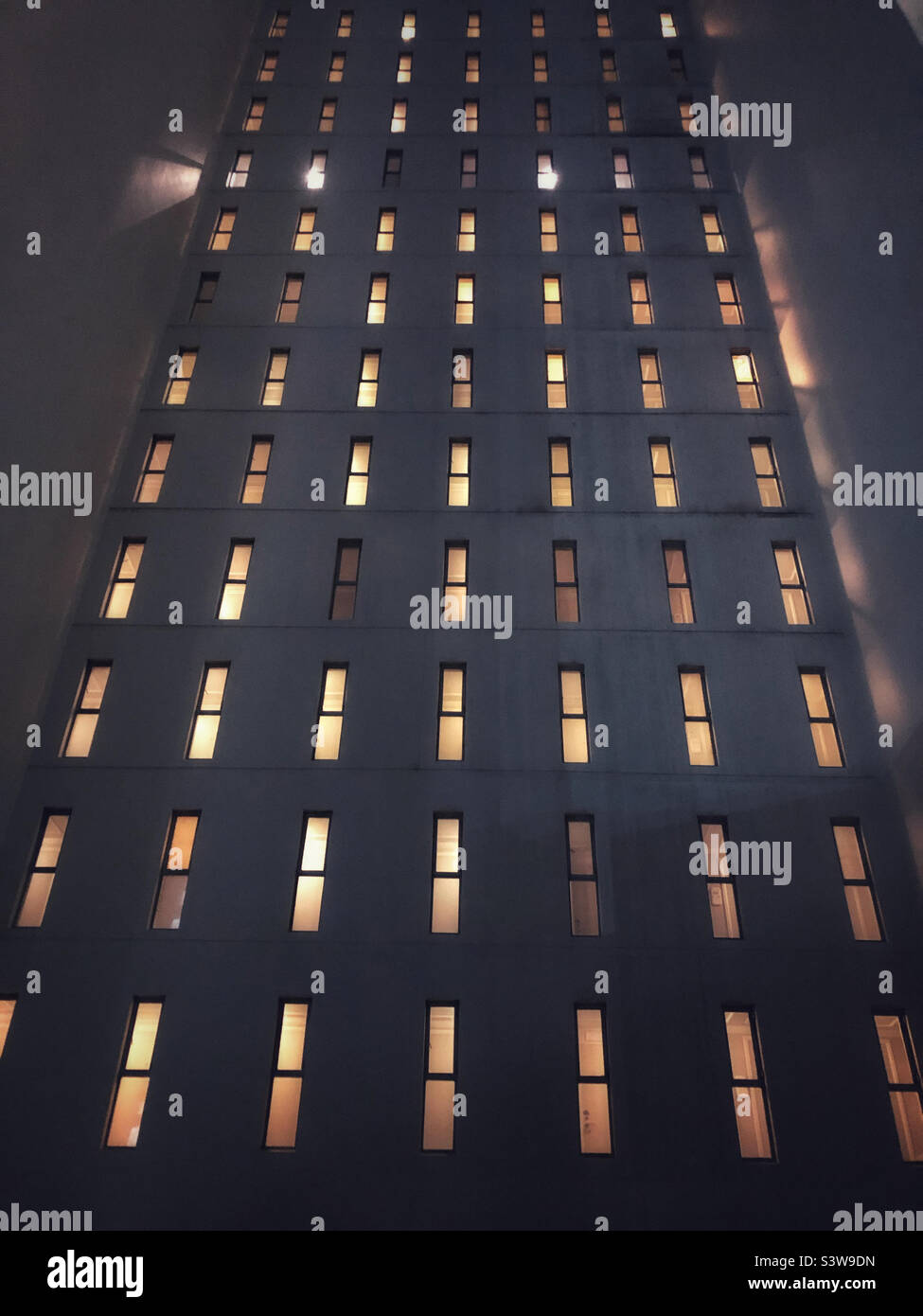 High rise hotel with lots of windows and lights at night Stock Photo - Alamy