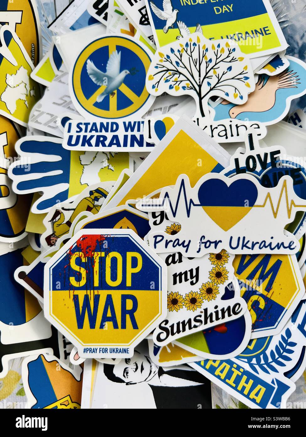 A pile of stickers in support of Ukraine with slogans like Stop War ...