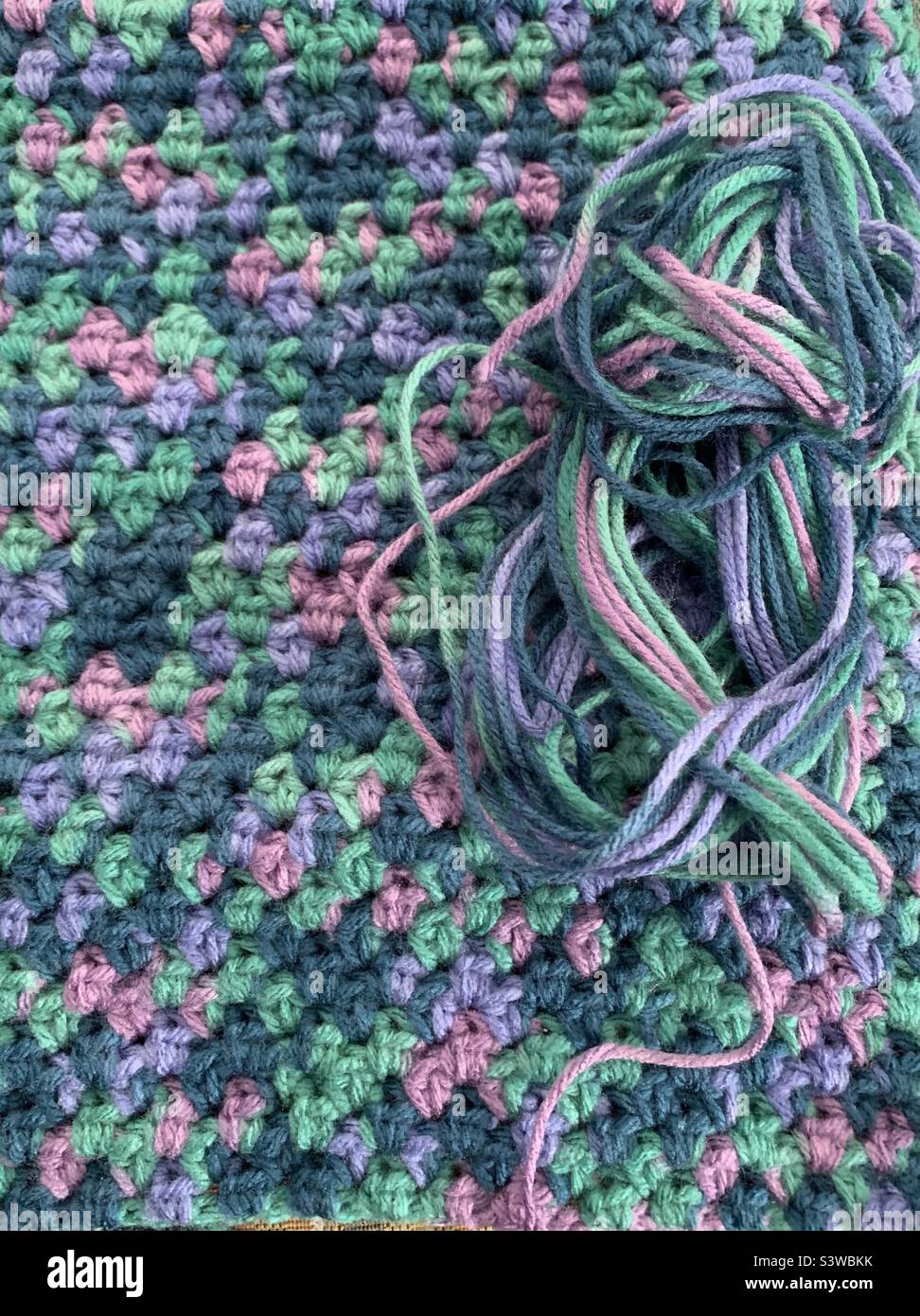 Yarn and colourful crocheted blanket Stock Photo - Alamy