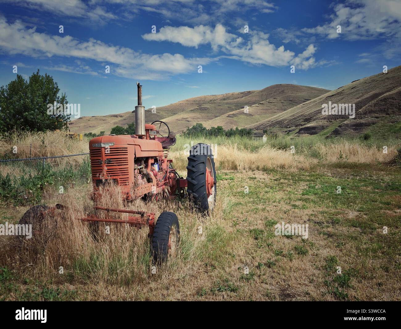 Rusty vintage tractor with Eastern Washington hillside in background ...