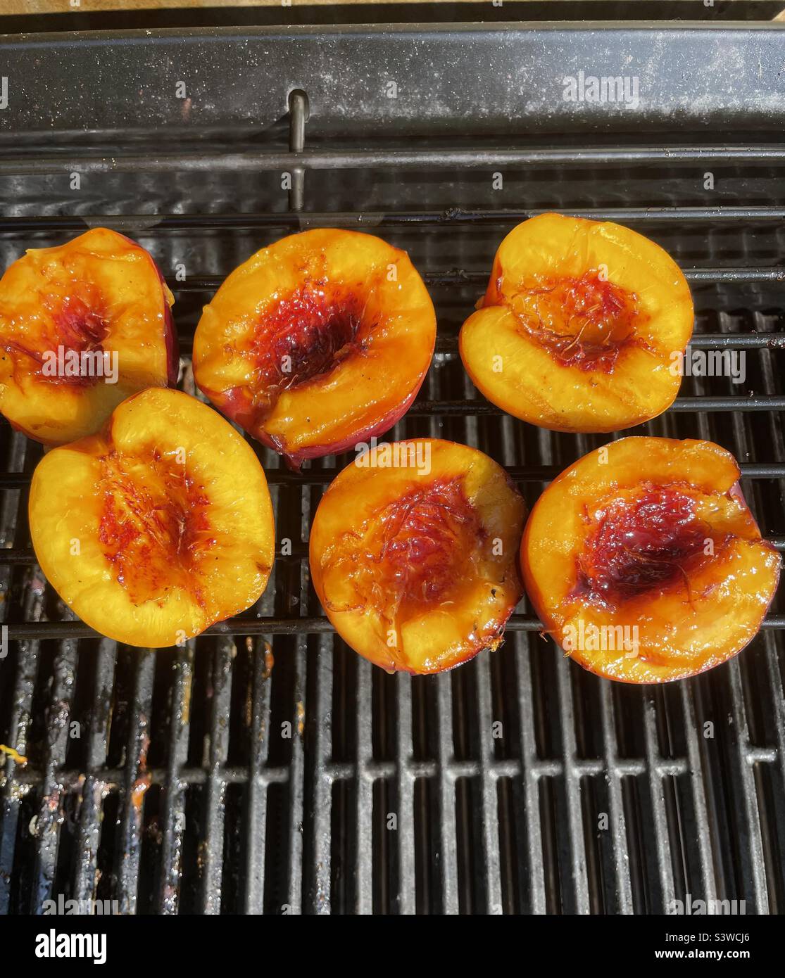 Caramelised nectarines grilled on a barbecue Stock Photo - Alamy