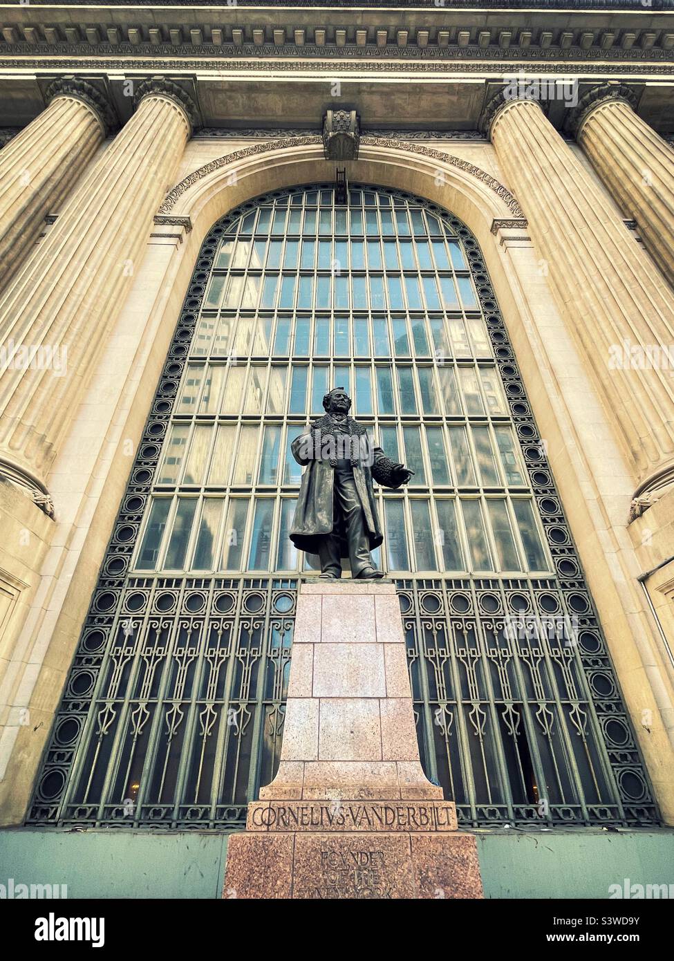 The statue of Commodore Cornelius Vanderbilt is in front of a large ...
