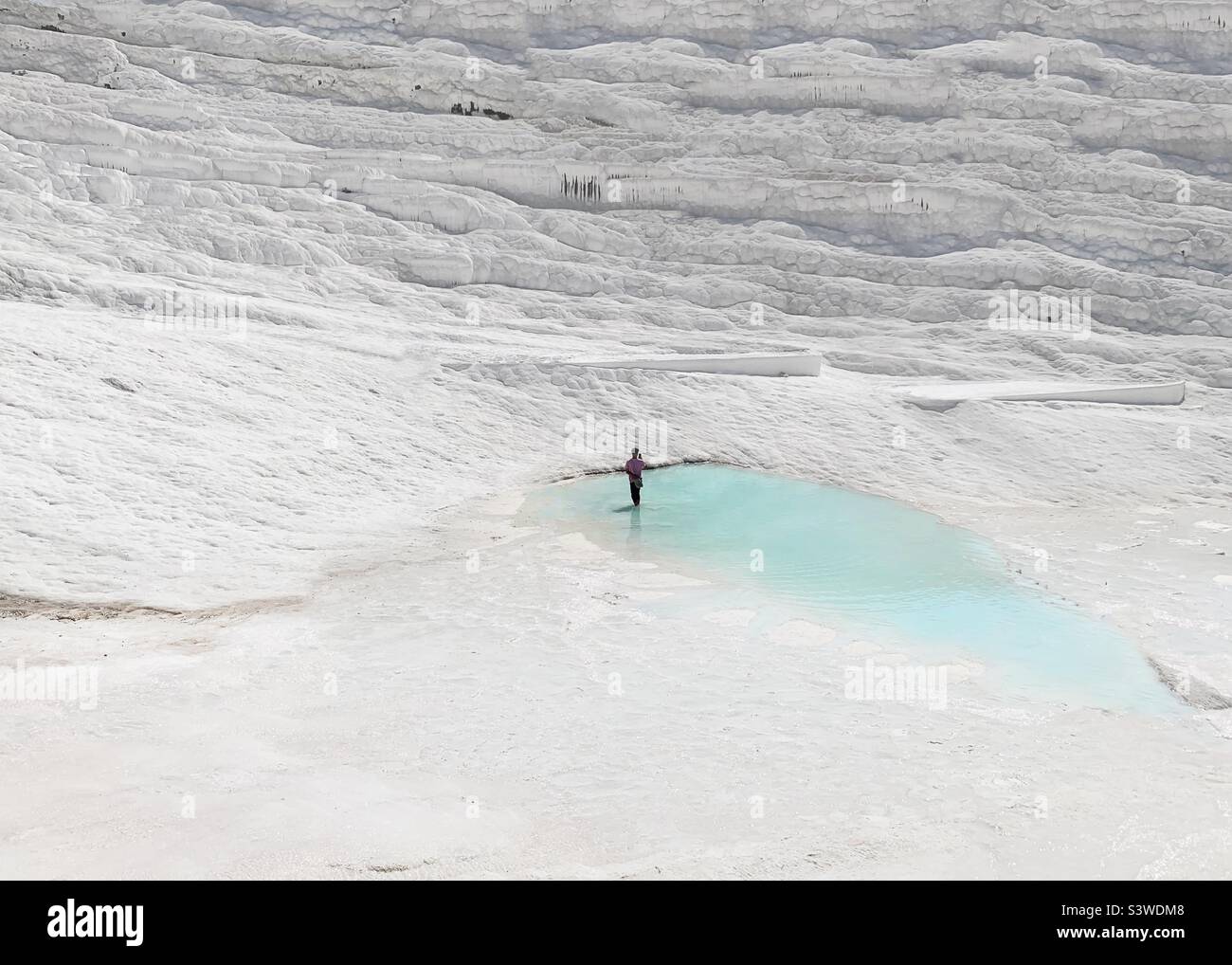 Tiny human silhouette standing in blue water lagoon Stock Photo - Alamy