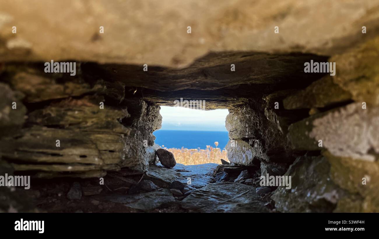 Ocean through the rocks Stock Photo - Alamy
