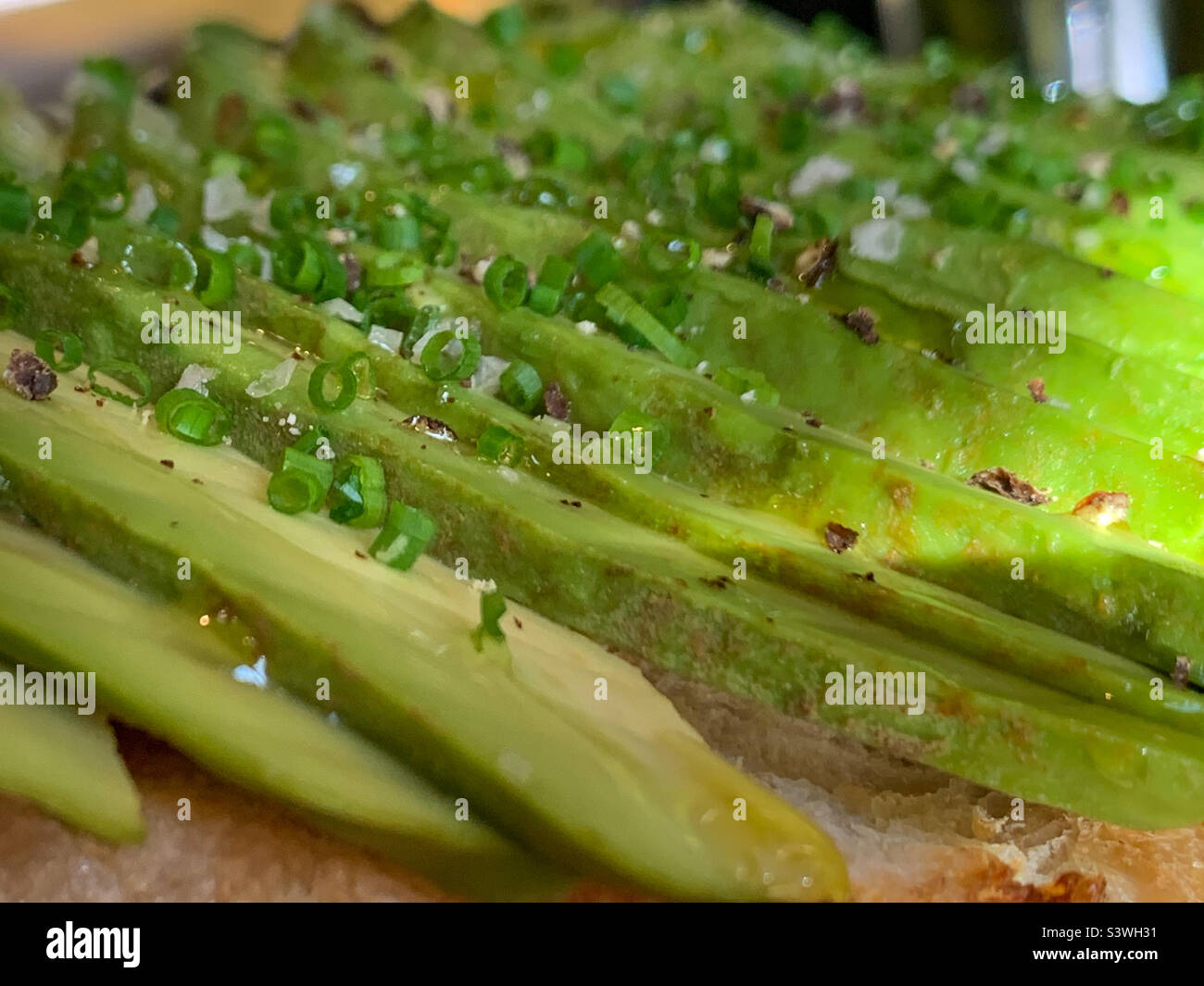Sliced avocado with seasoning, fresh, green, fruit, salt and pepper and ...