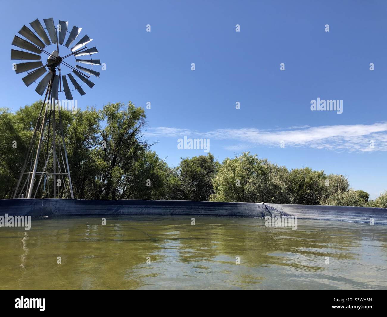Windmill. Reliable source of water. But no wind today Stock Photo - Alamy
