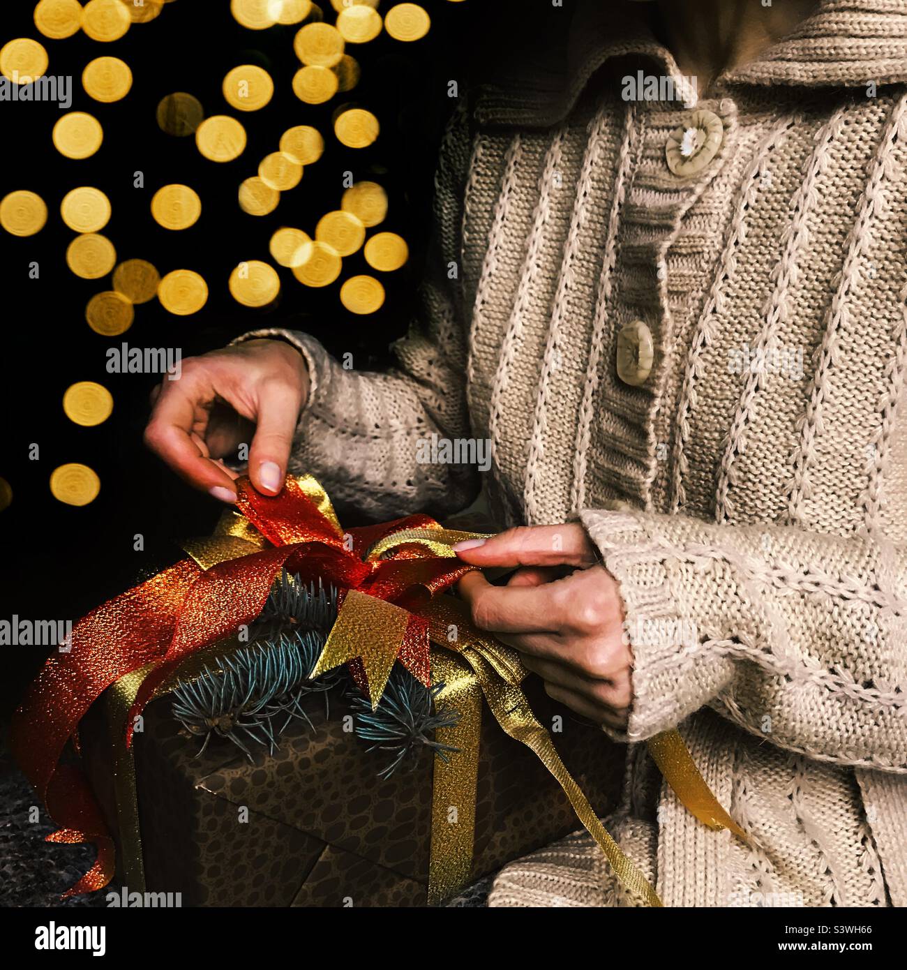Unpacking Christmas gift box at night Stock Photo - Alamy