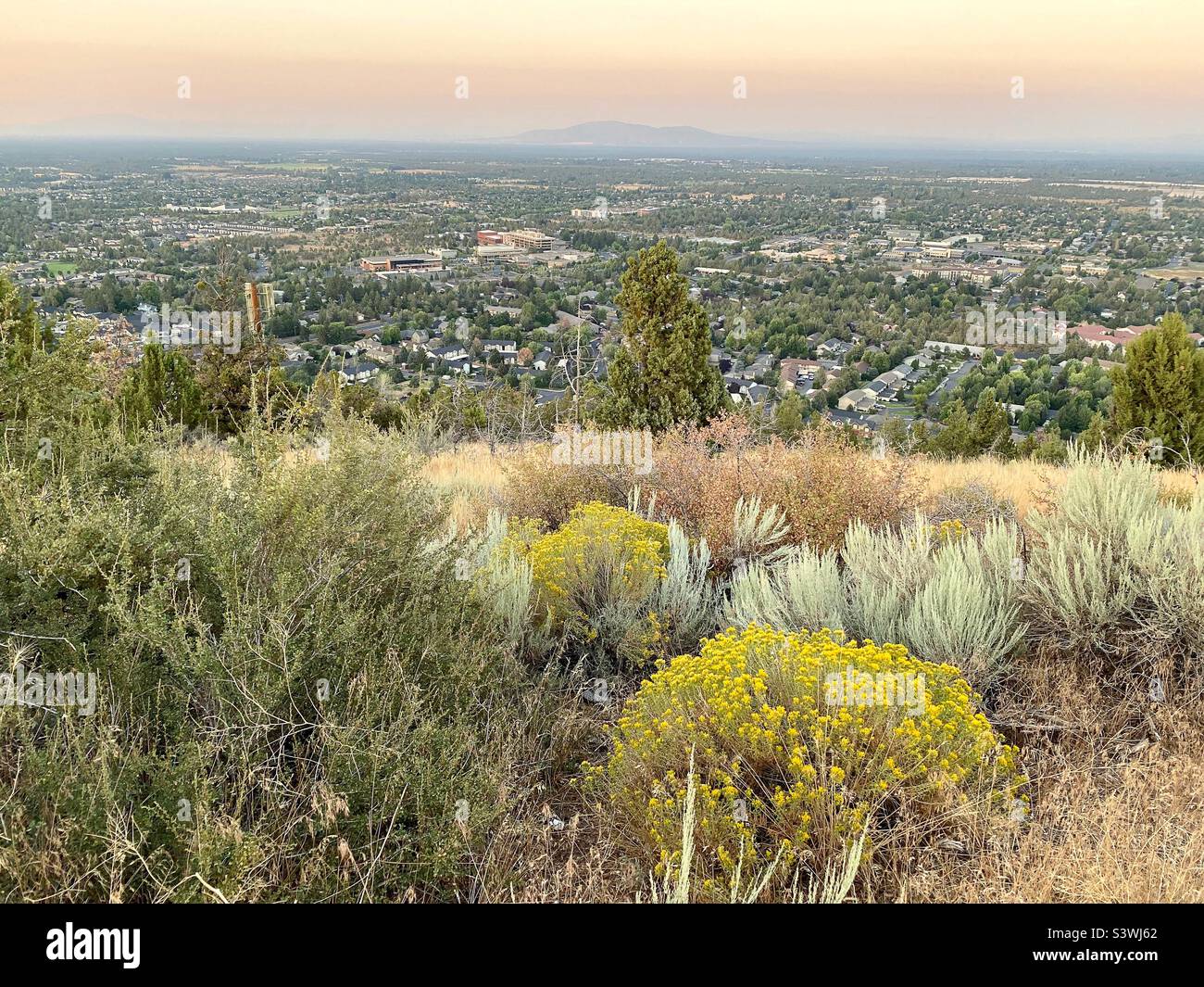 View of Bend, Oregon, from the top of Pilot Butte, with layer of orange ...
