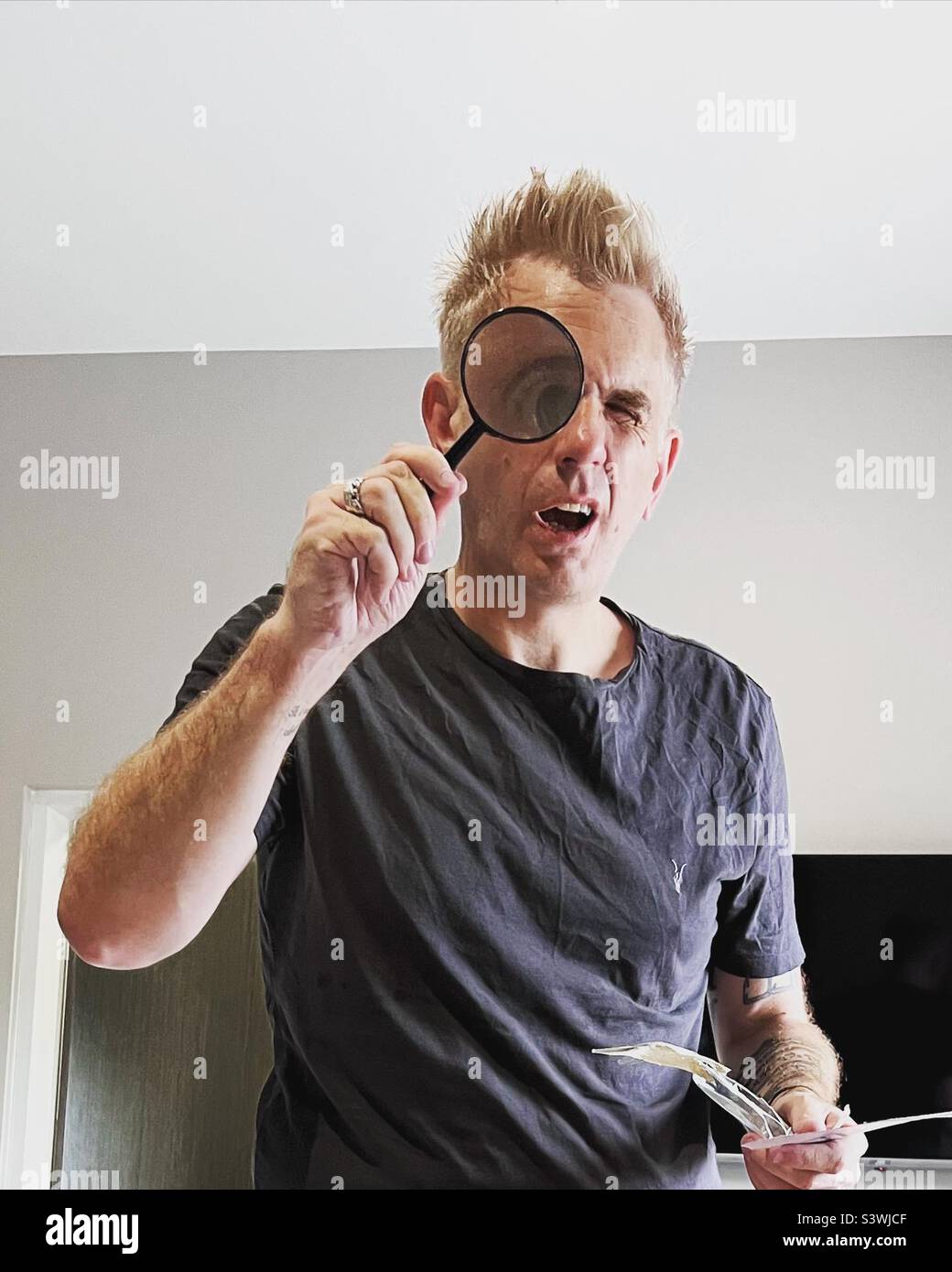 Man using magnifying glass Stock Photo - Alamy