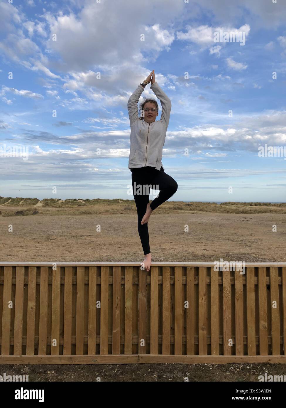 Young girl balance on a fence Stock Photo - Alamy