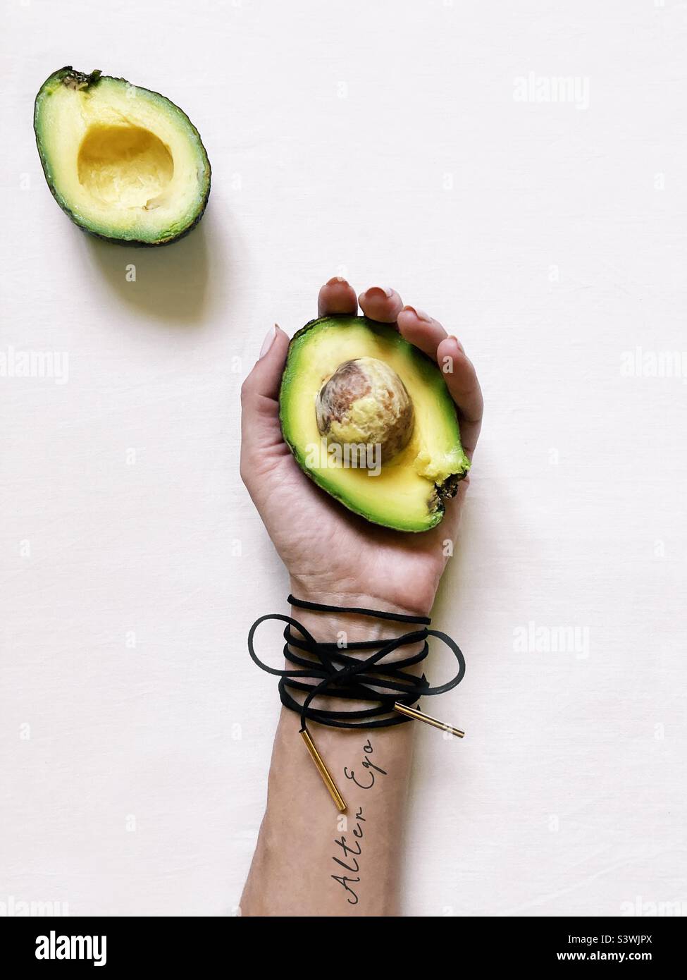Woman hand holding avocado hi-res stock photography and images - Alamy