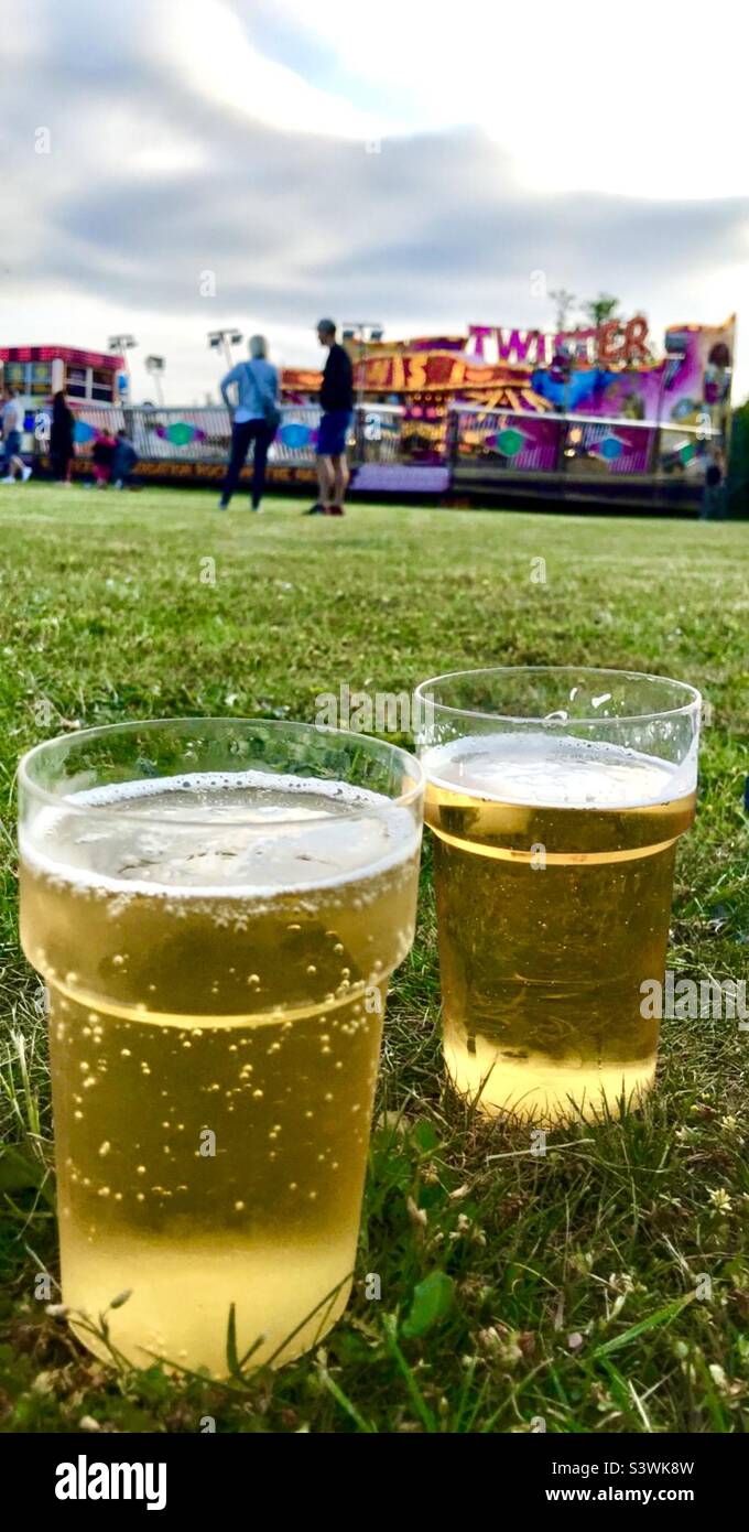 Enjoying a refreshing pint at the funfair Stock Photo - Alamy