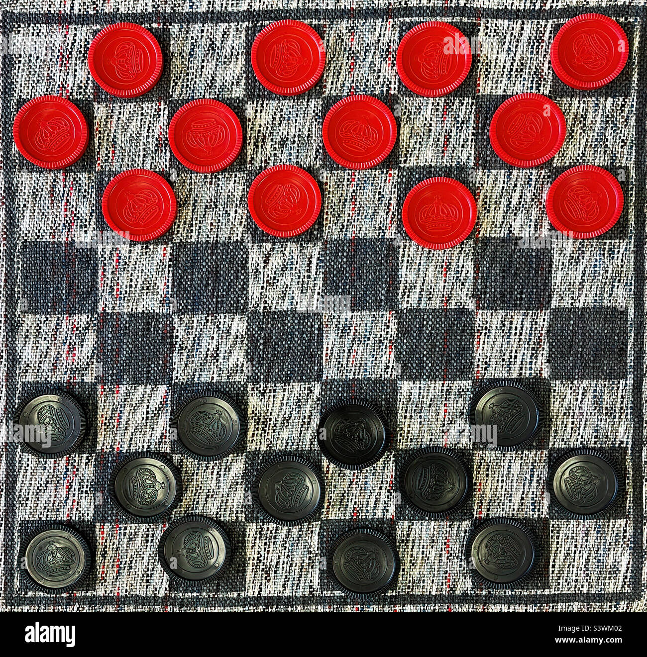 Red and black colored checkers on a fabric checker board Stock Photo ...