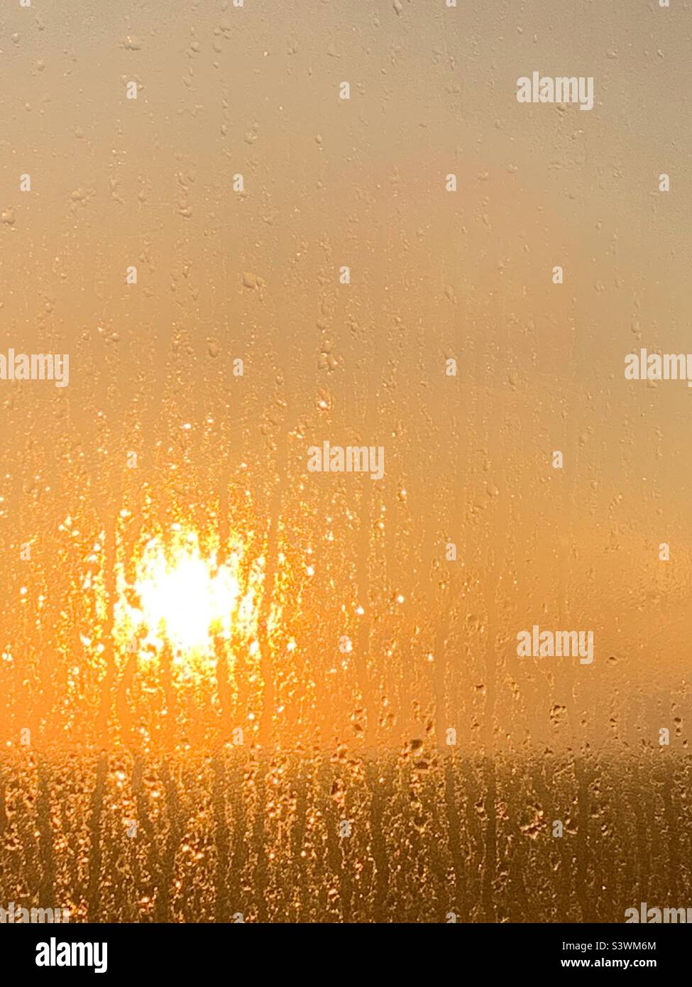 Early morning sunrise seen through condensation on a window Stock Photo ...