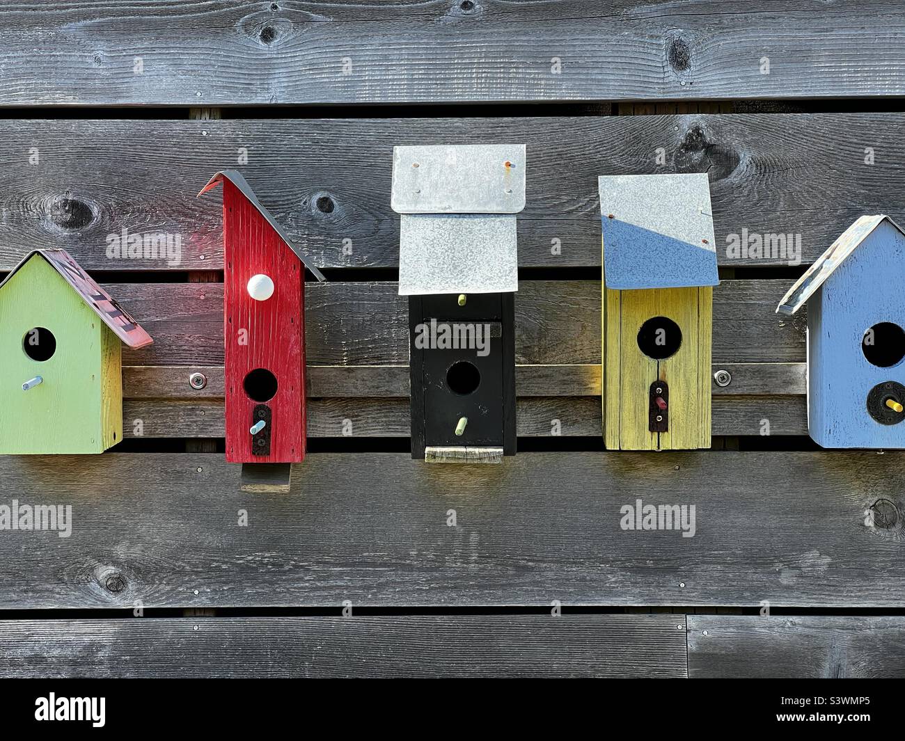 Colorful bird houses on the side of a home near the ocean Stock Photo ...