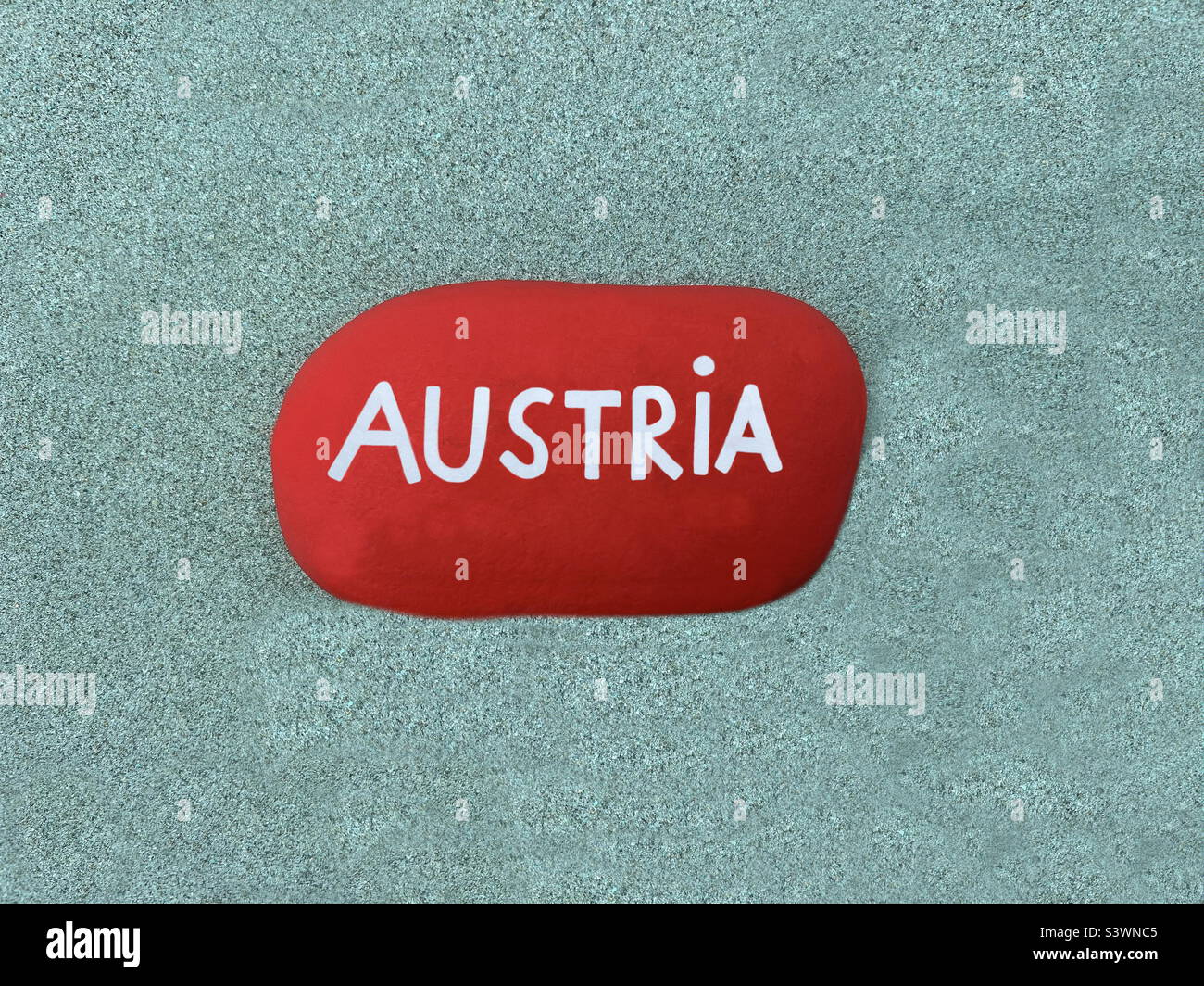 Austria, souvenir composed with a red and white hand painted stone over ...