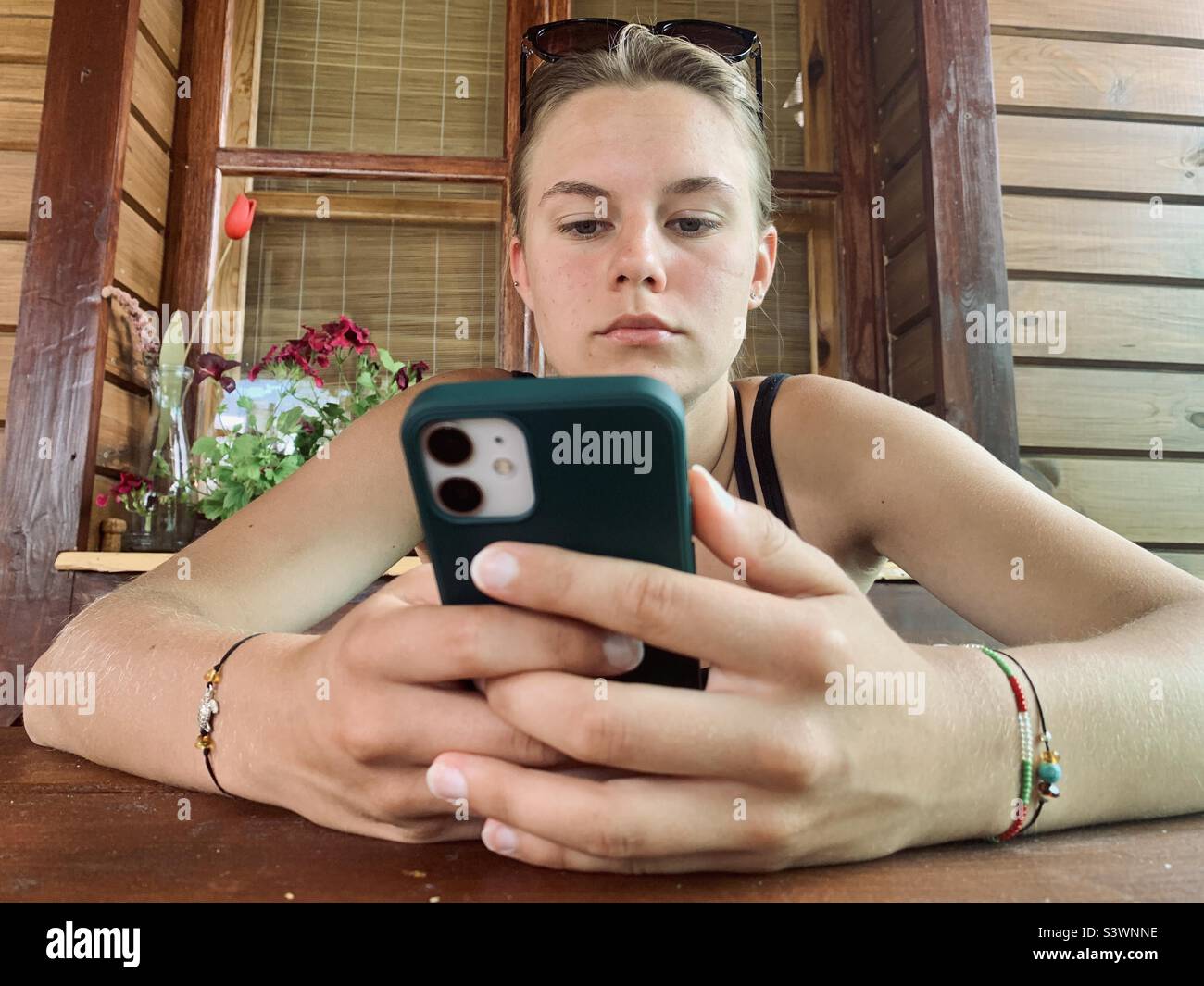 Young teenage girl browsing smartphone in summer day Stock Photo - Alamy
