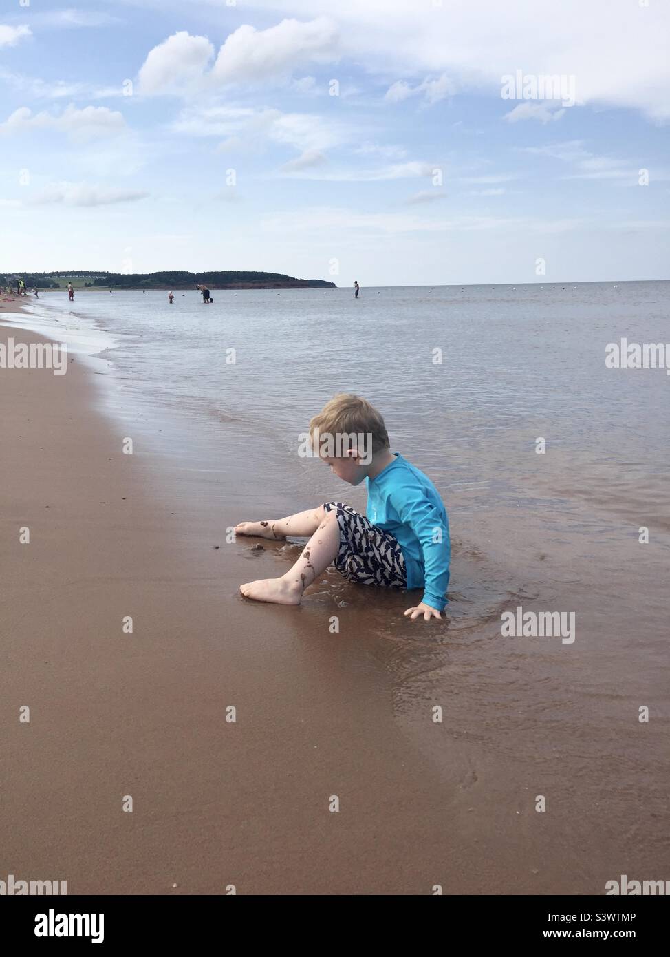 A young boy enjoying a beach day in Prince Edward Island Canada Stock ...